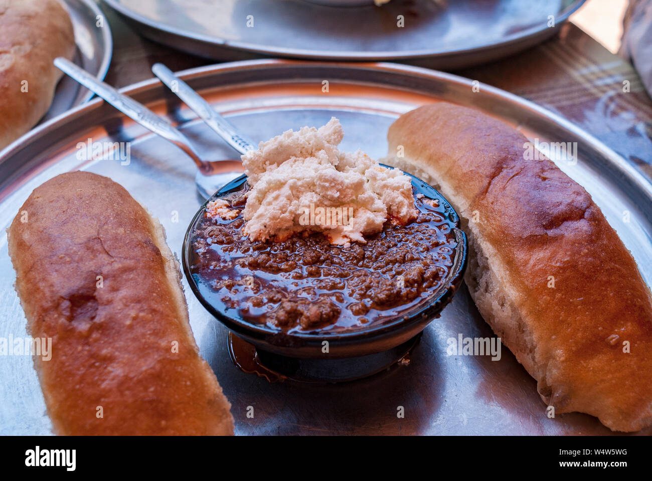 Ethiopian Kitfo (mince) with cheese and bread, served on a metal plate ...