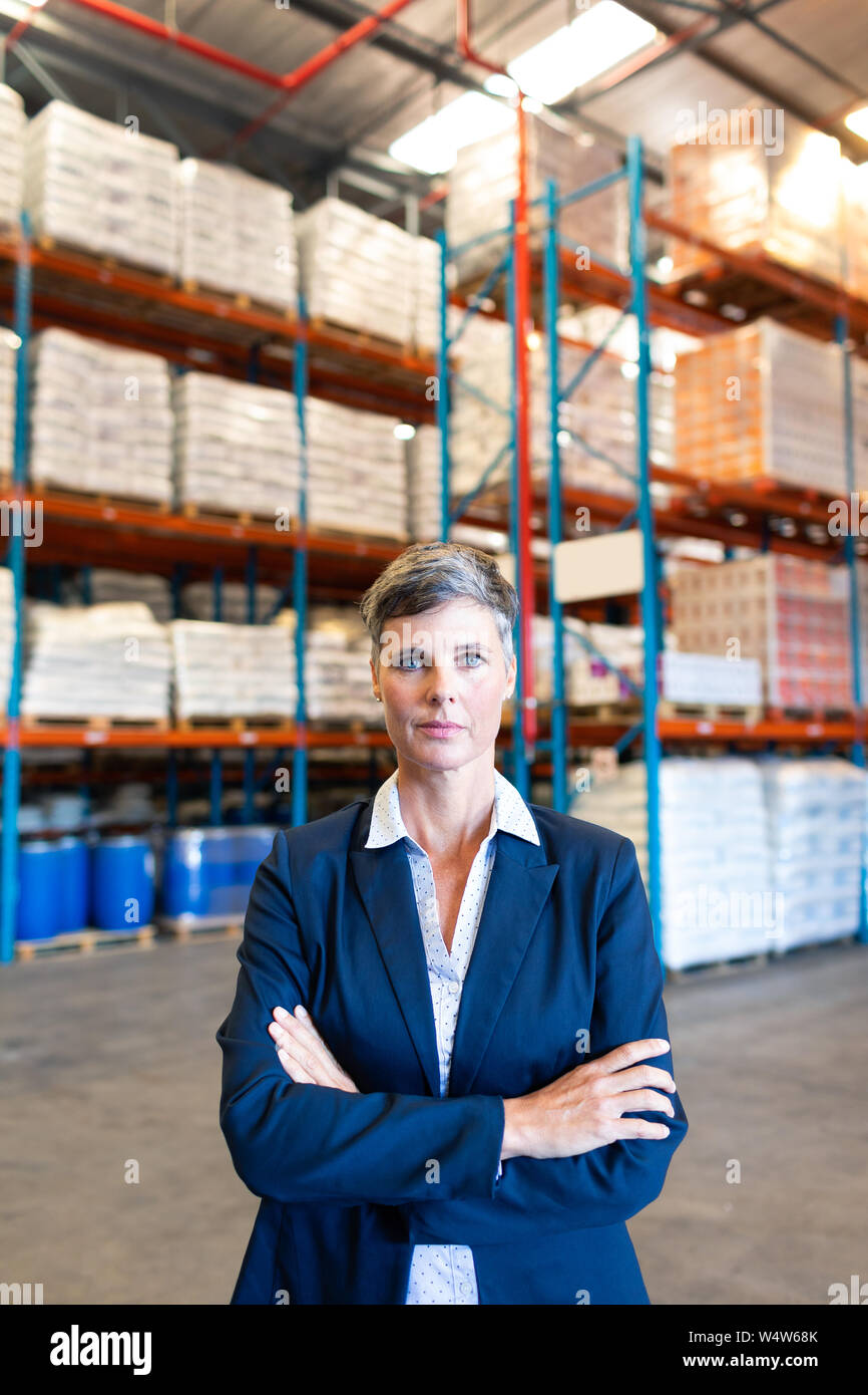 Female manager standing with arm crossed and looking at camera in ...