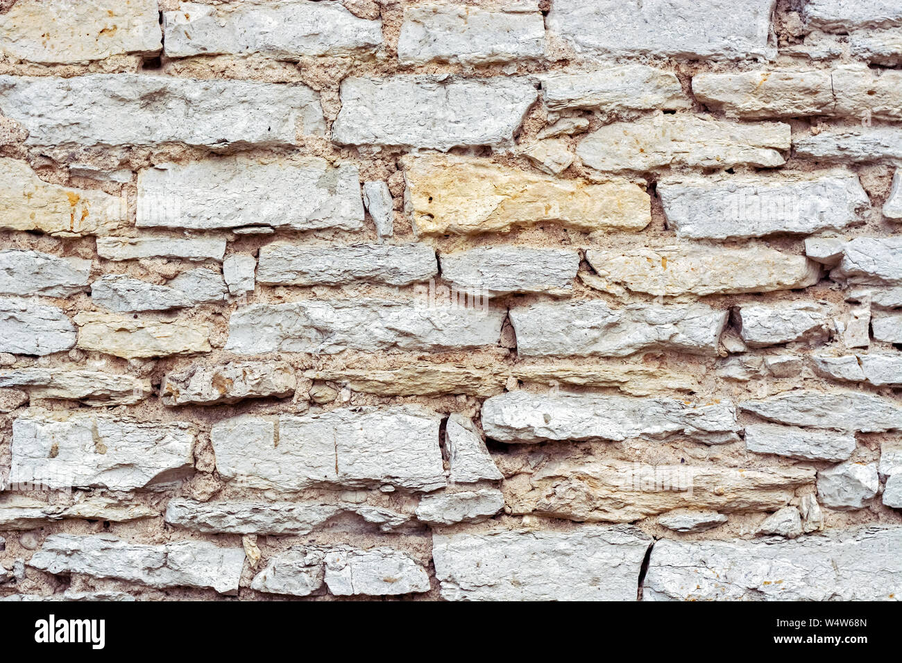 Fragment of an old stone wall made of limestone for use as an abstract ...