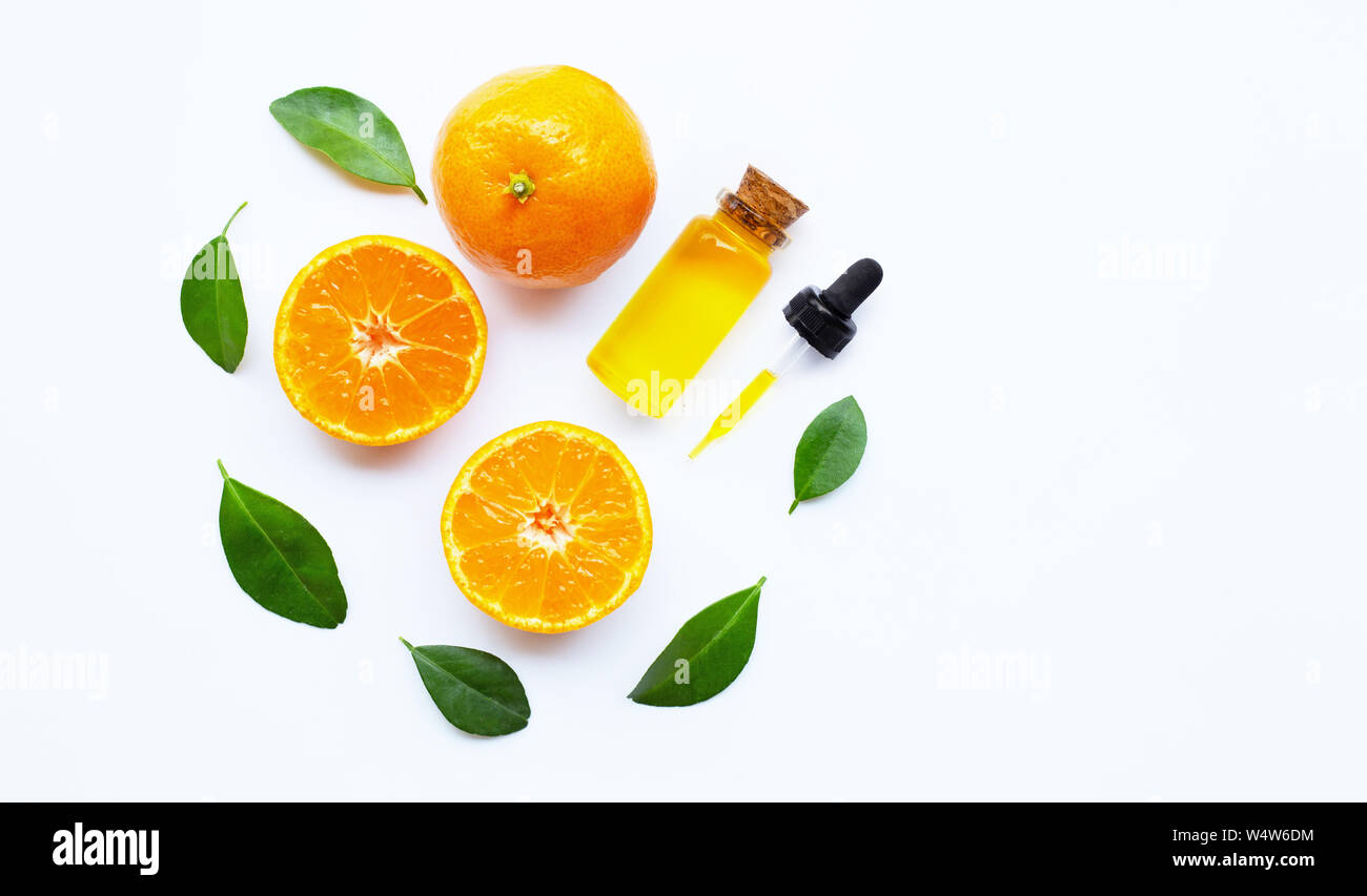 Essential oil with oranges on white background Stock Photo - Alamy