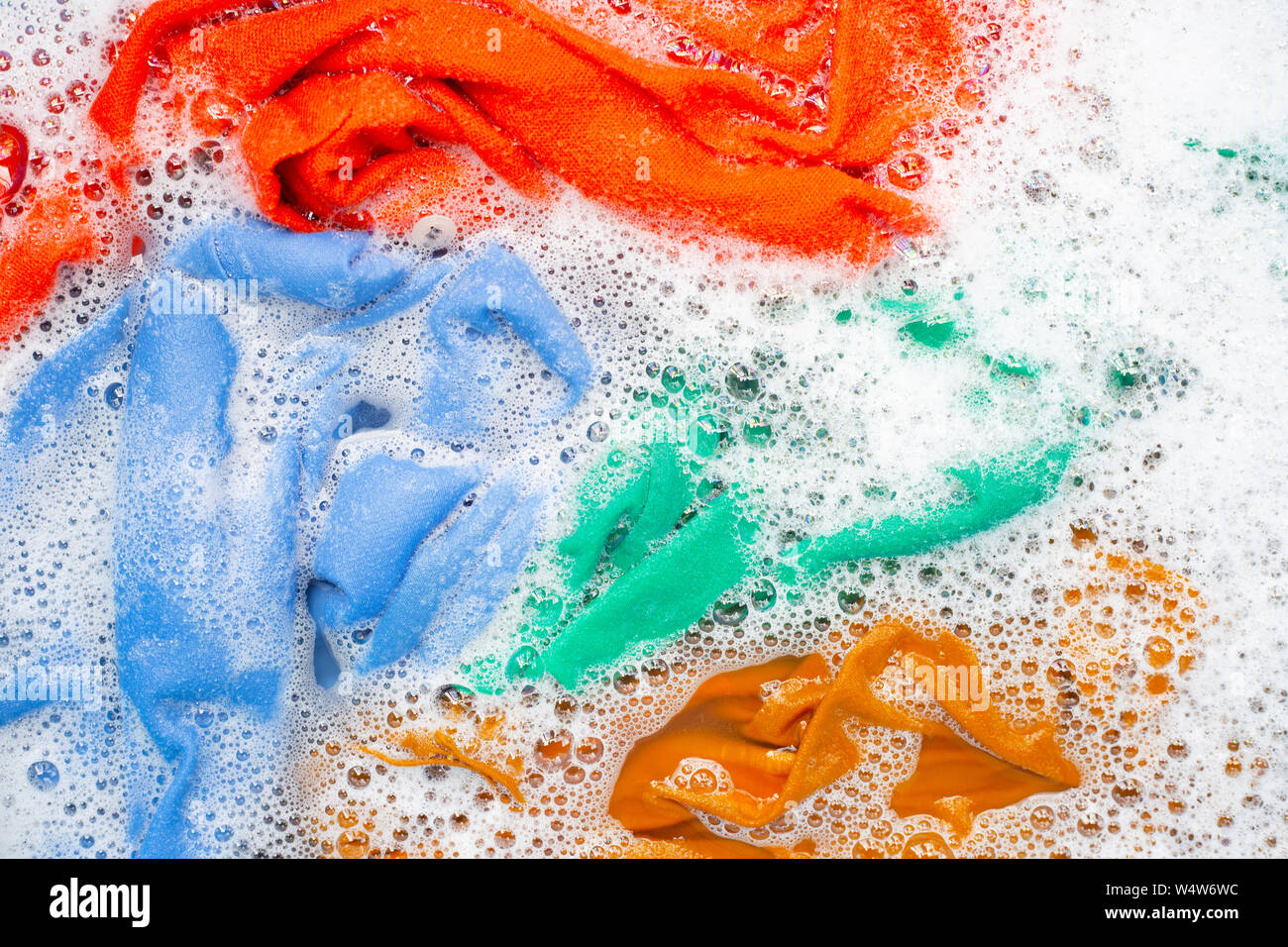 Color clothes soak before washing. Top view Stock Photo - Alamy