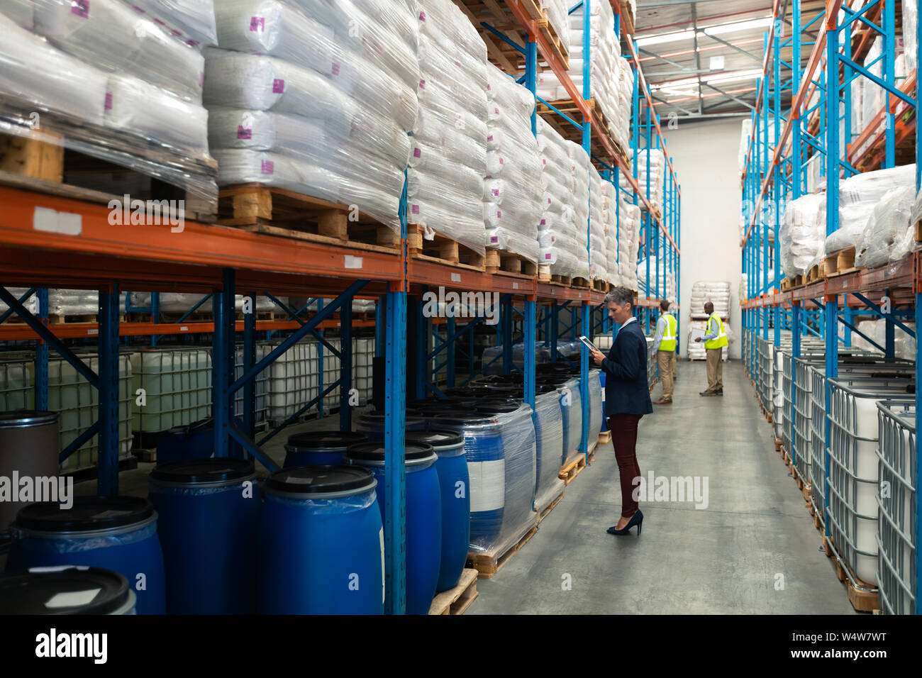 Warehouse staff checking stocks in warehouse Stock Photo - Alamy
