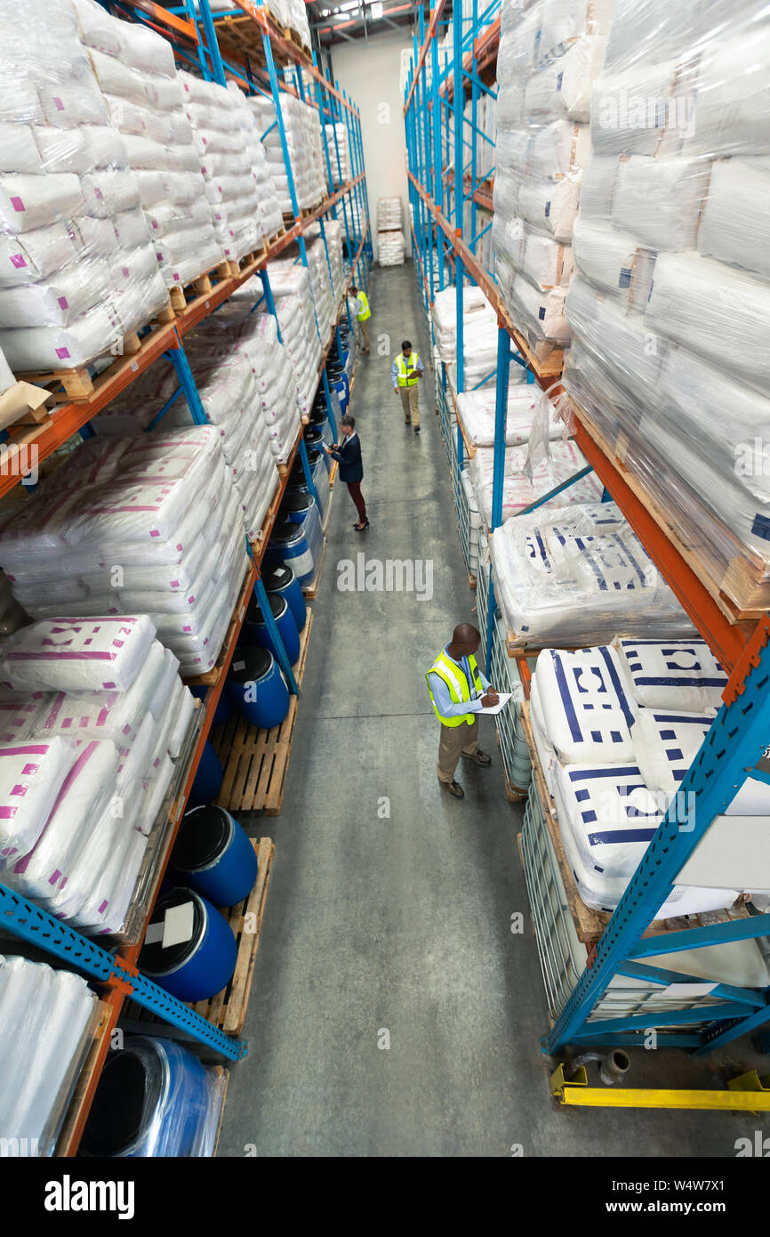 Warehouse staff checking stocks in warehouse Stock Photo - Alamy