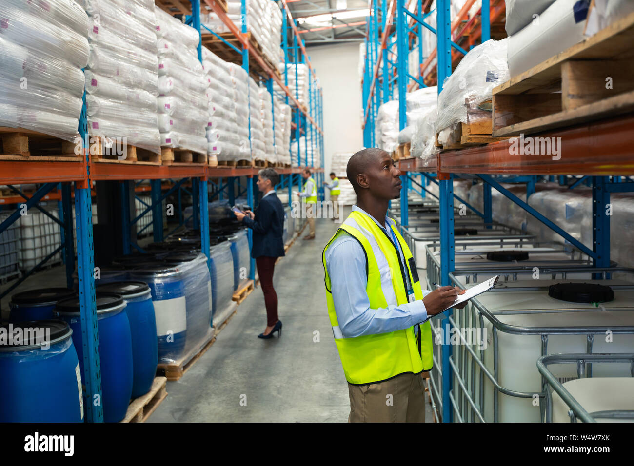 Warehouse staff checking stocks in warehouse Stock Photo - Alamy