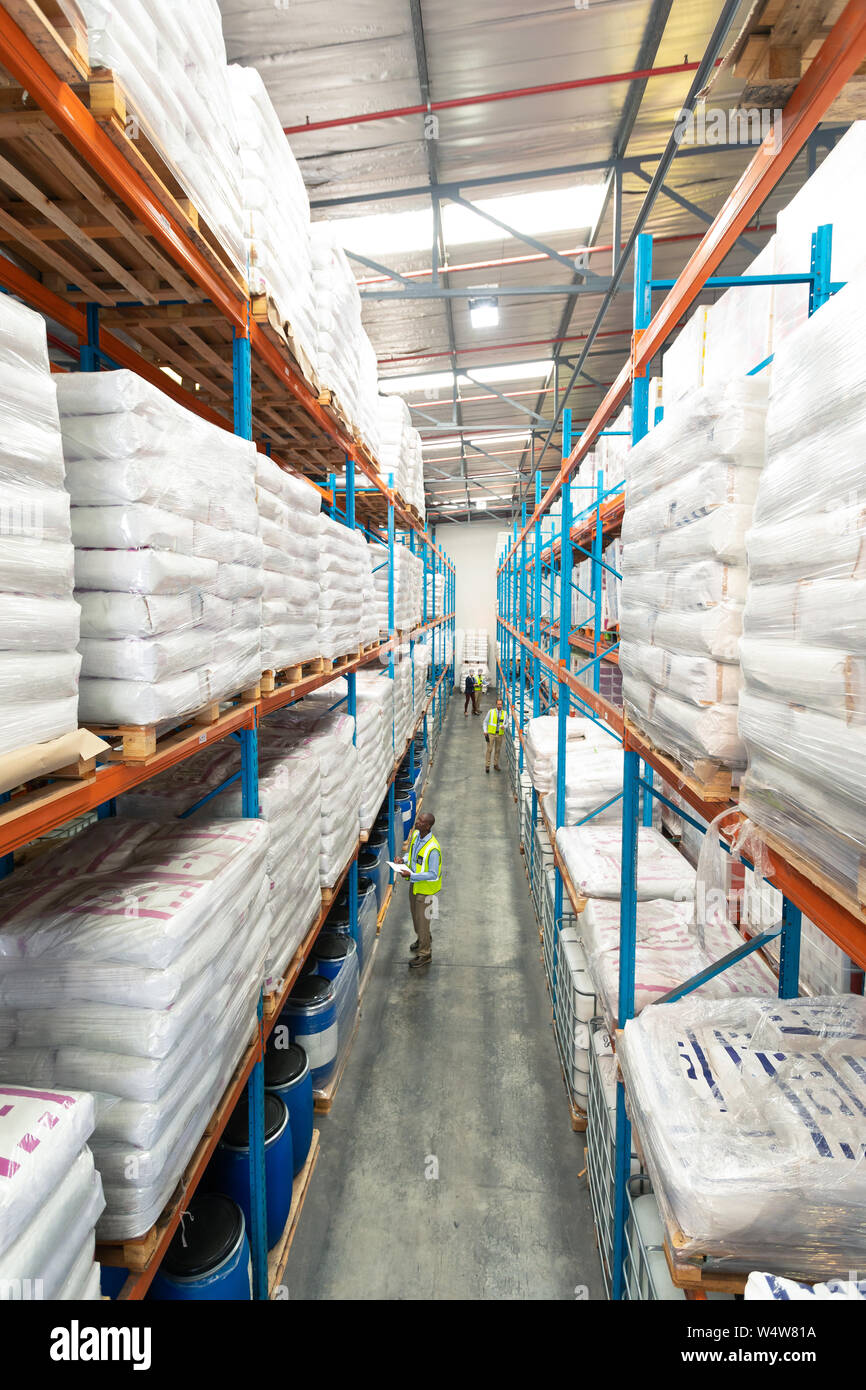 Warehouse staff checking stocks in warehouse Stock Photo - Alamy