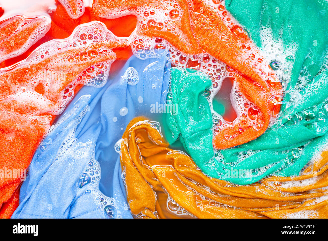 Color clothes soak before washing. Top view Stock Photo - Alamy