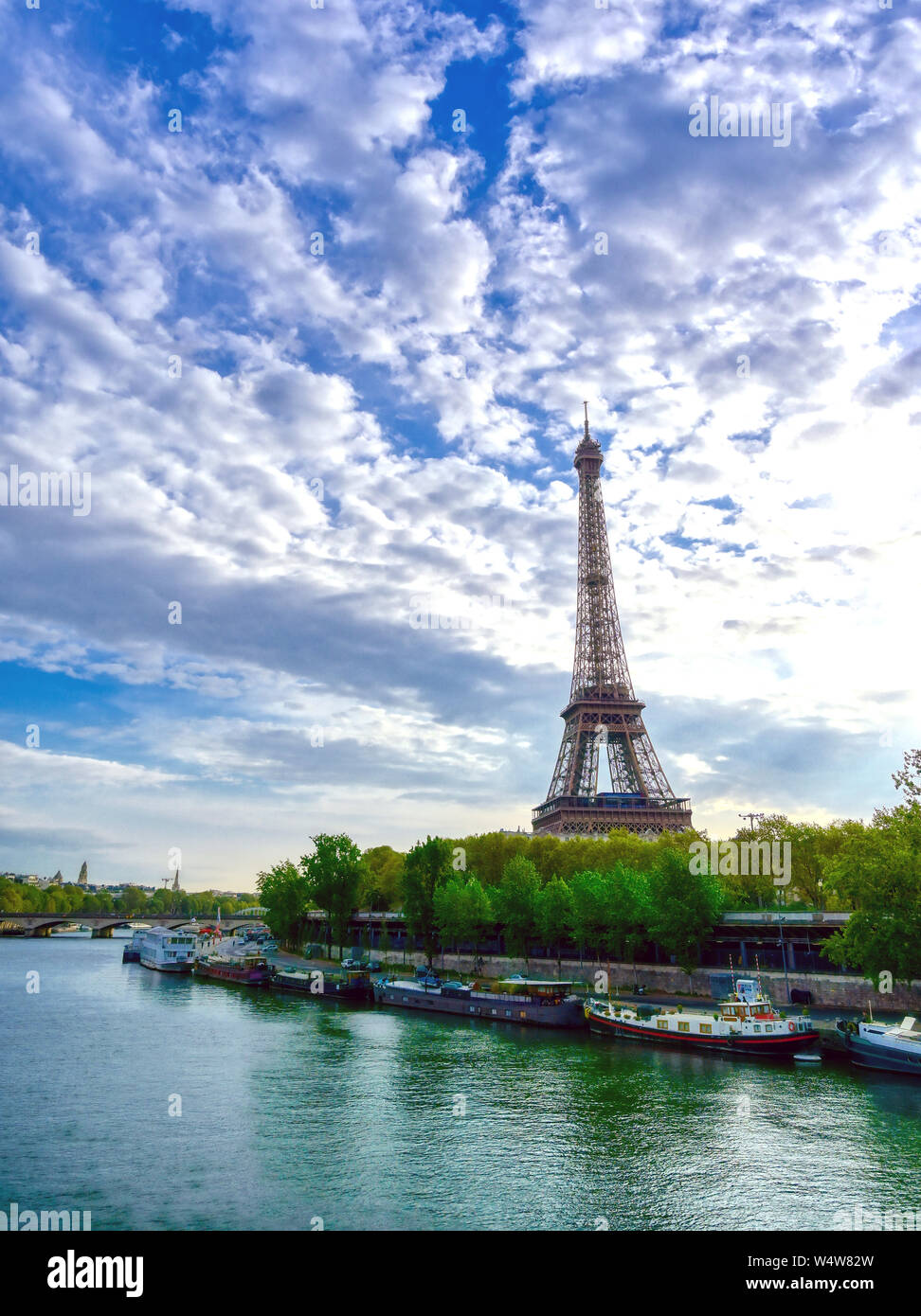The Eiffel Tower across the Seine River in Paris, France on a sunny day ...