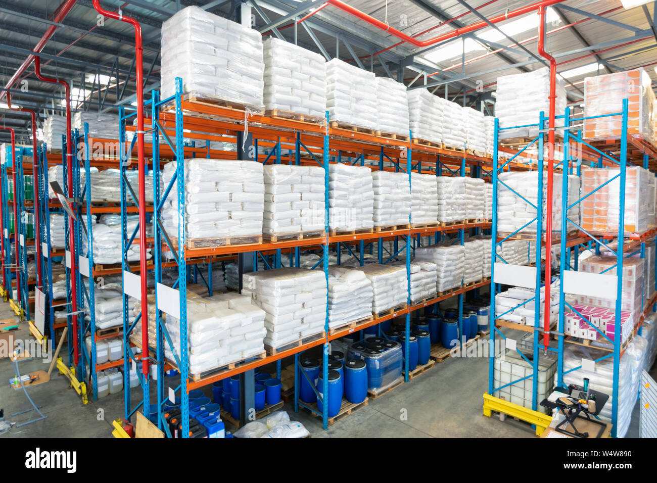 Barrel and goods arranged on a rack in warehouse Stock Photo - Alamy