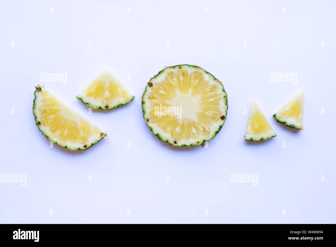 Pineapple slices on white background Stock Photo - Alamy