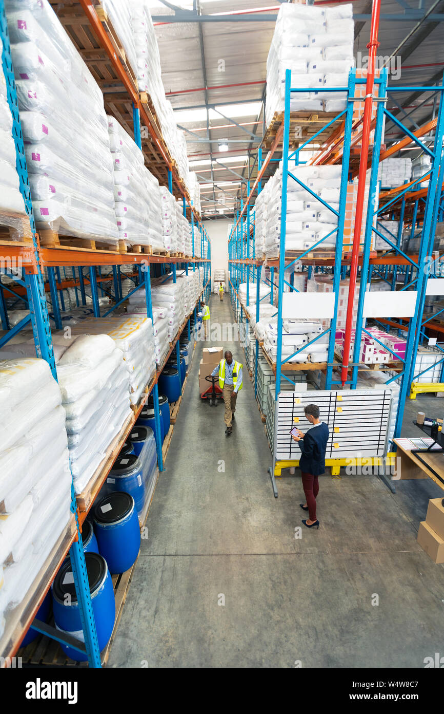 Warehouse staff working together in warehouse Stock Photo - Alamy