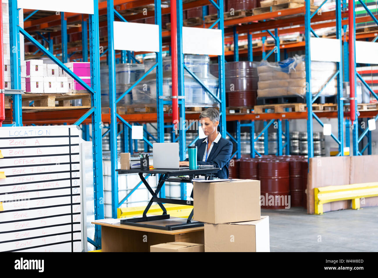 Female manager working at desk in workhouse Stock Photo - Alamy