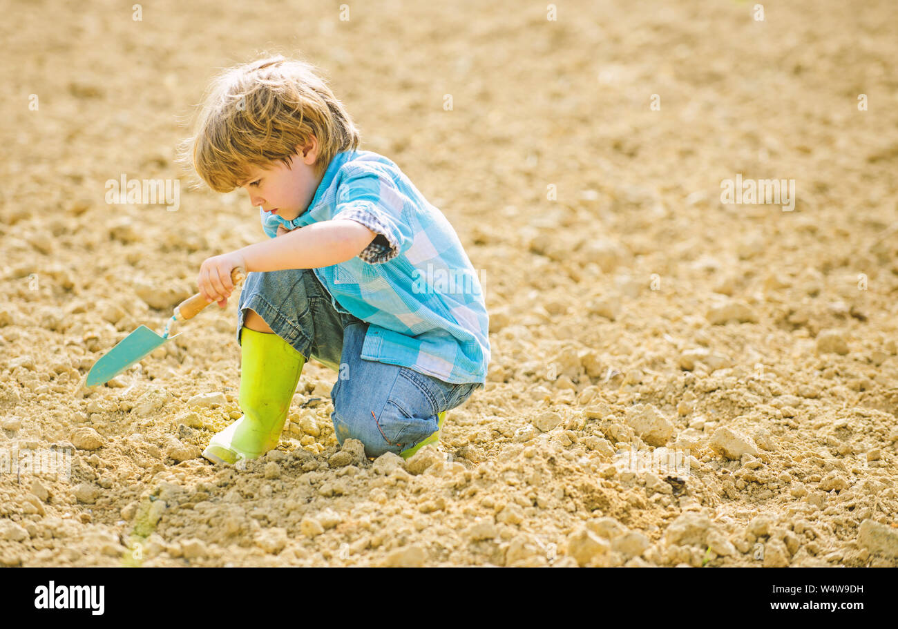 farming and agriculture. small kid planting a flower. ecology life ...