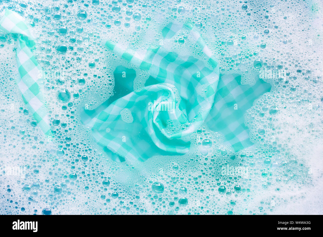 Green white tablecloth soak in powder detergent water dissolution ...