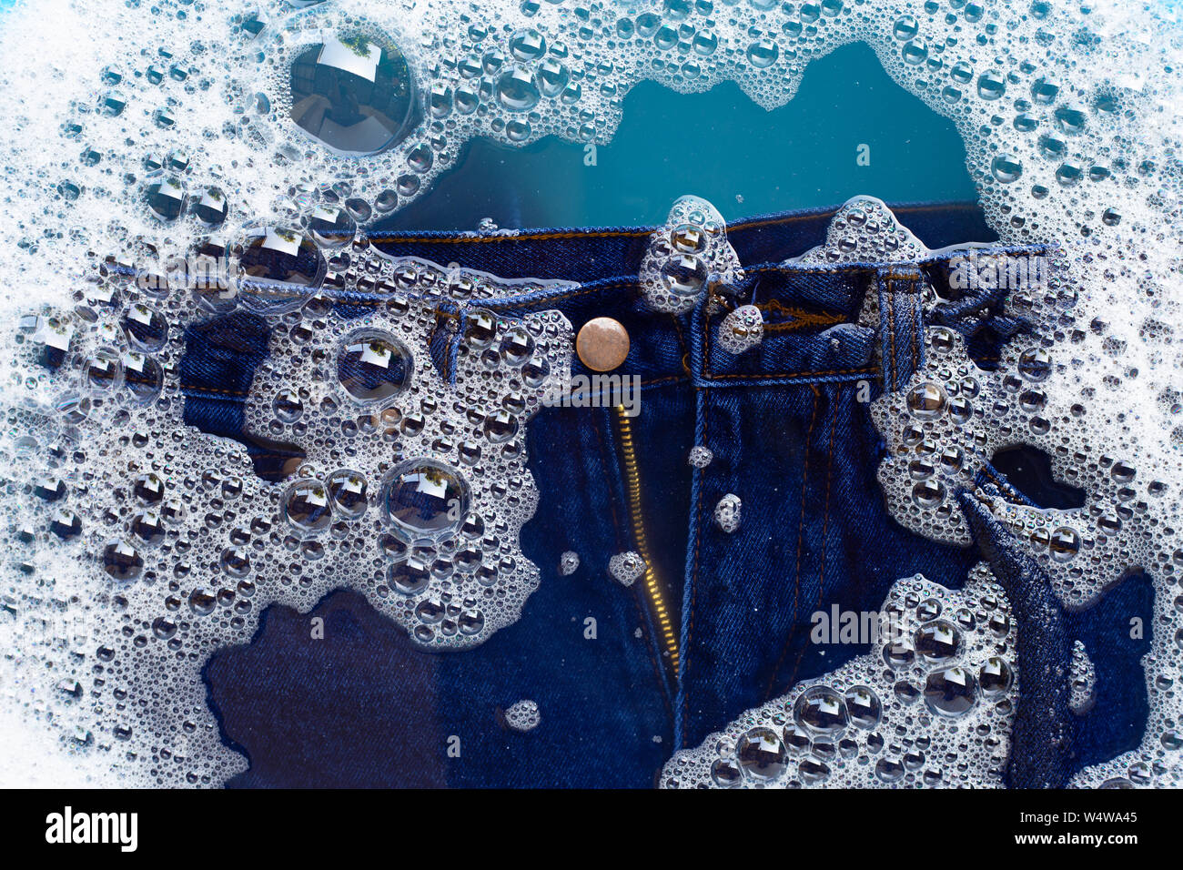 Jeans soak in powder detergent water dissolution, washing cloth ...