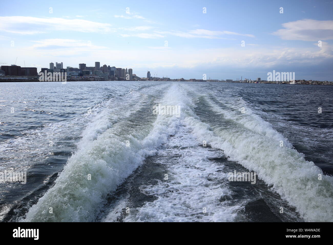 Water Rushing Behind Boat in Ocean City in Background Stock Photo - Alamy