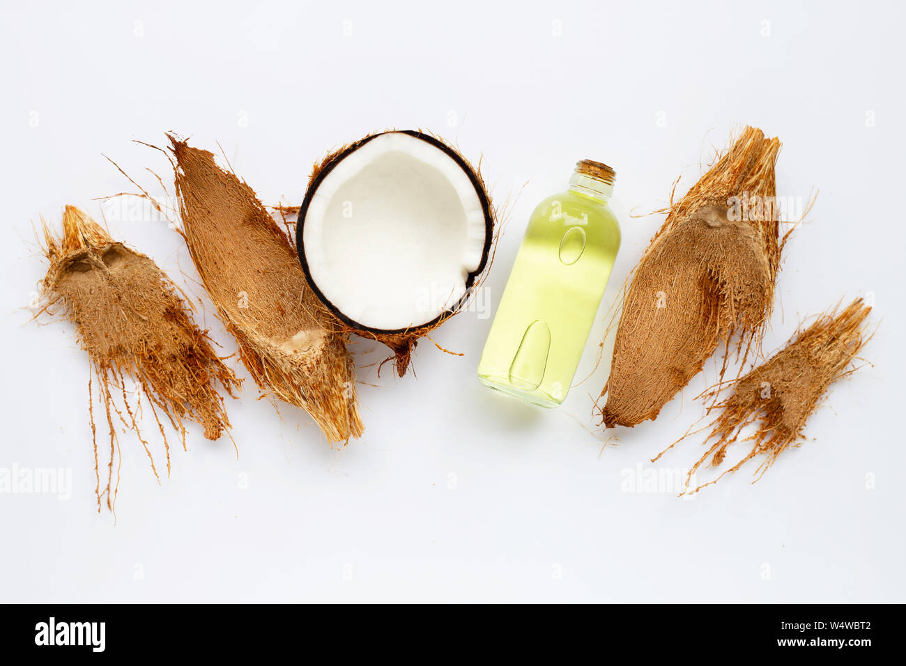 Coconut oil with coconuts on white background Stock Photo - Alamy