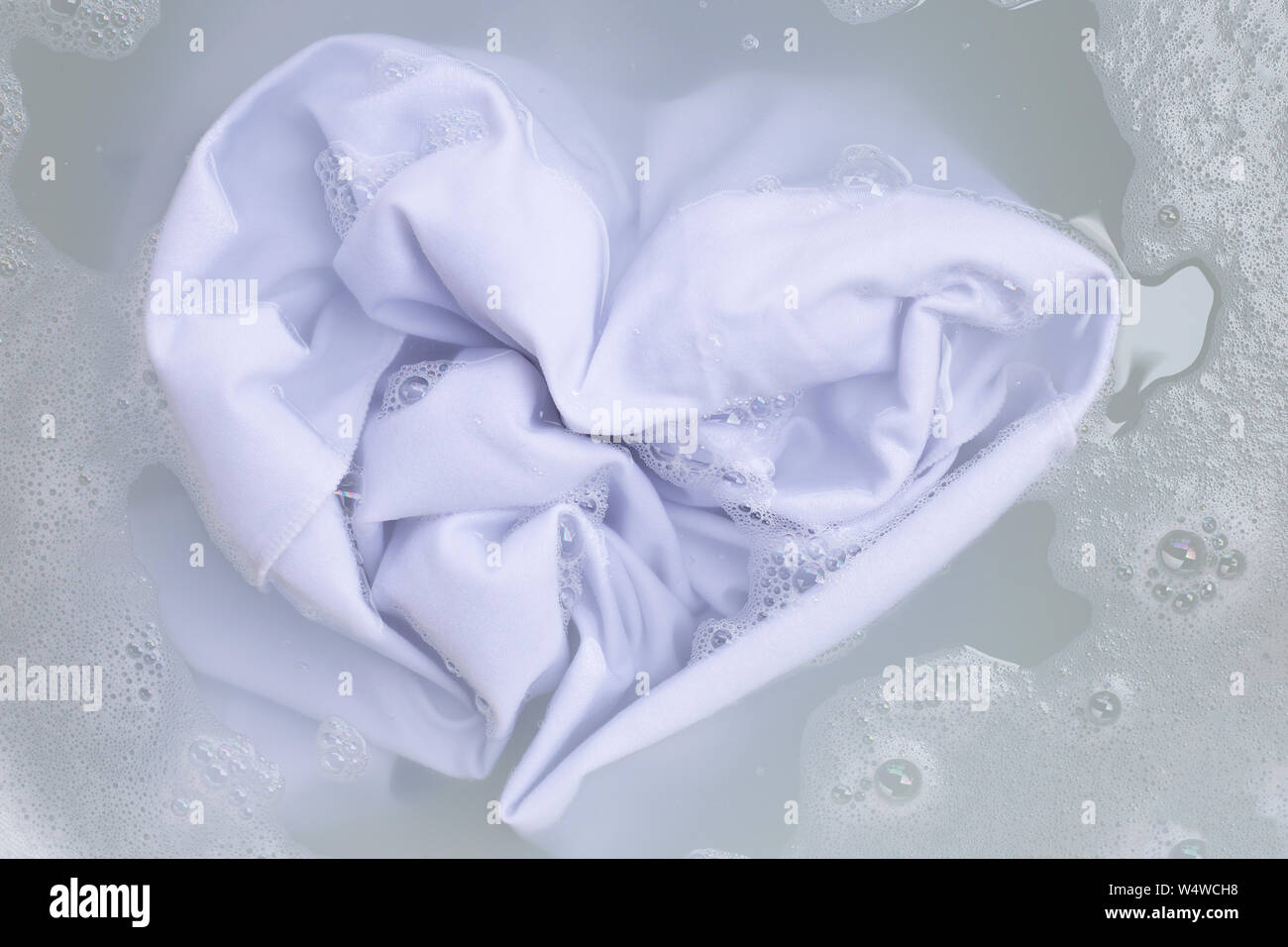 Soak a cloth before washing, white cloth. Top view Stock Photo - Alamy