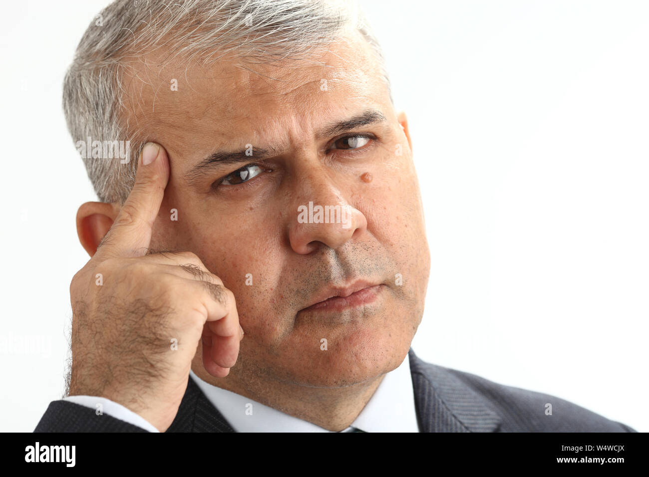 Indian businessman thinking Stock Photo - Alamy