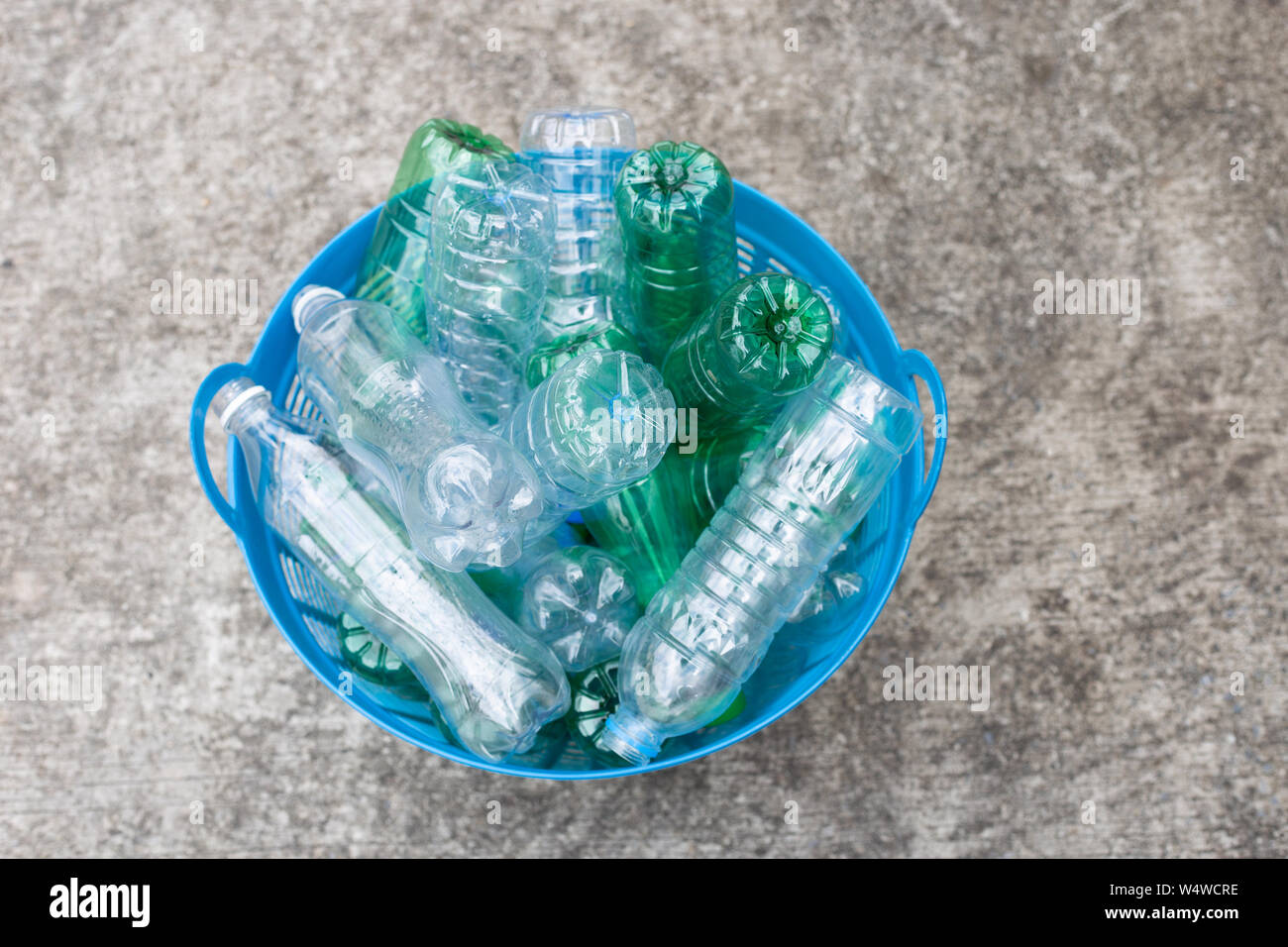 Plastic bottles in blue waste basket Stock Photo - Alamy