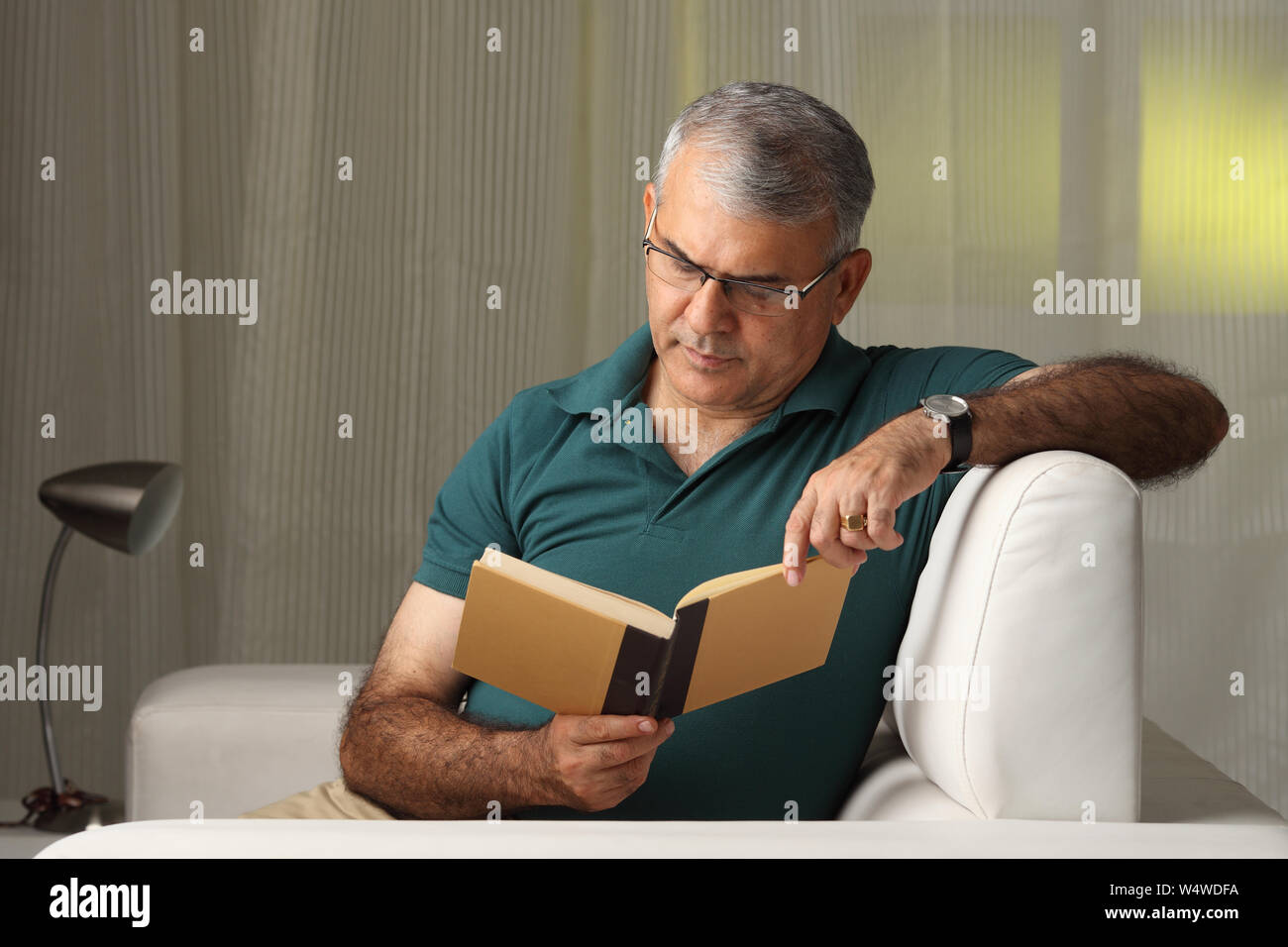 Indian old man reading book hi-res stock photography and images - Alamy
