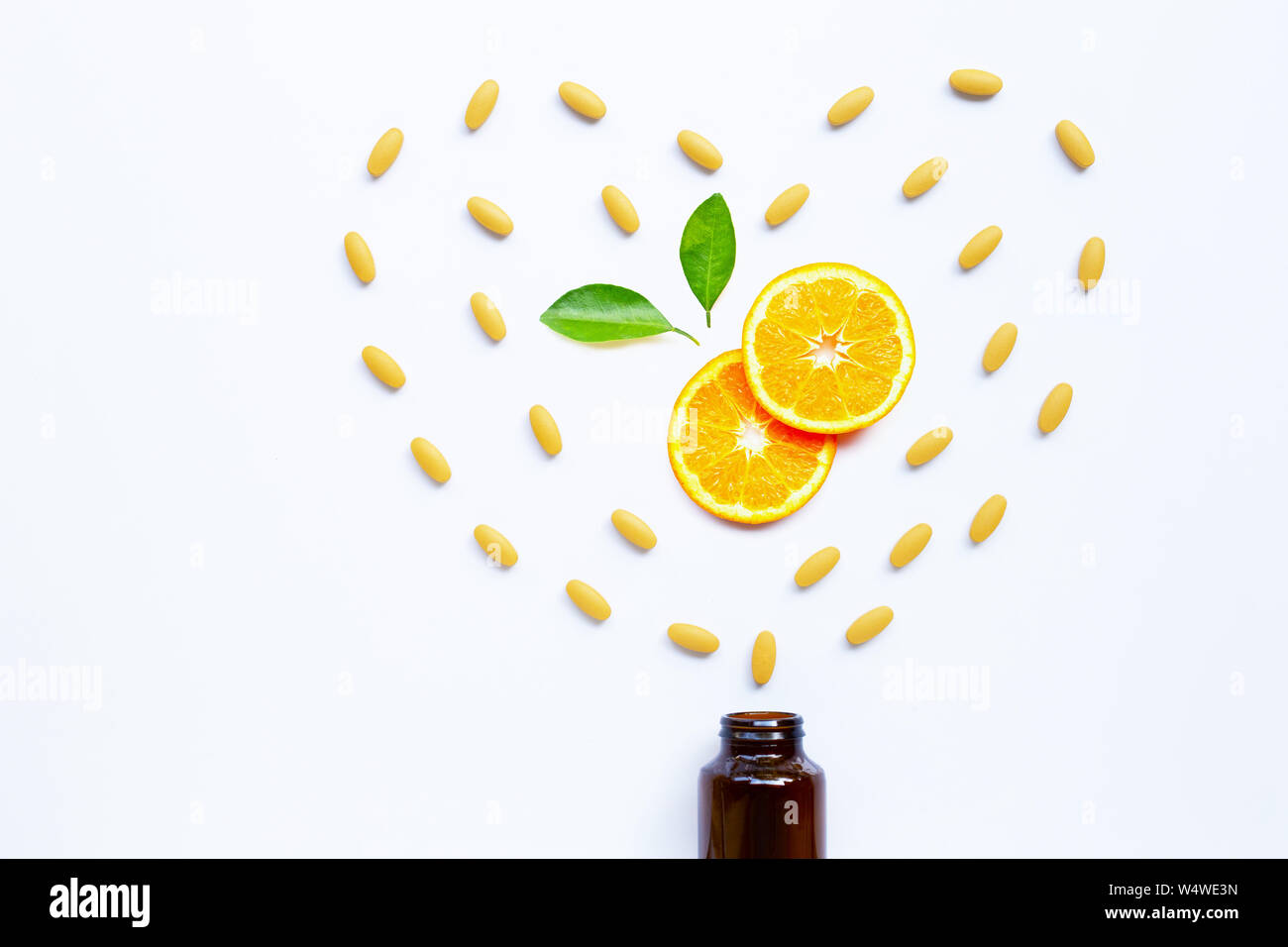 Vitamin C bottle and pills with orange fruit on white background Stock ...