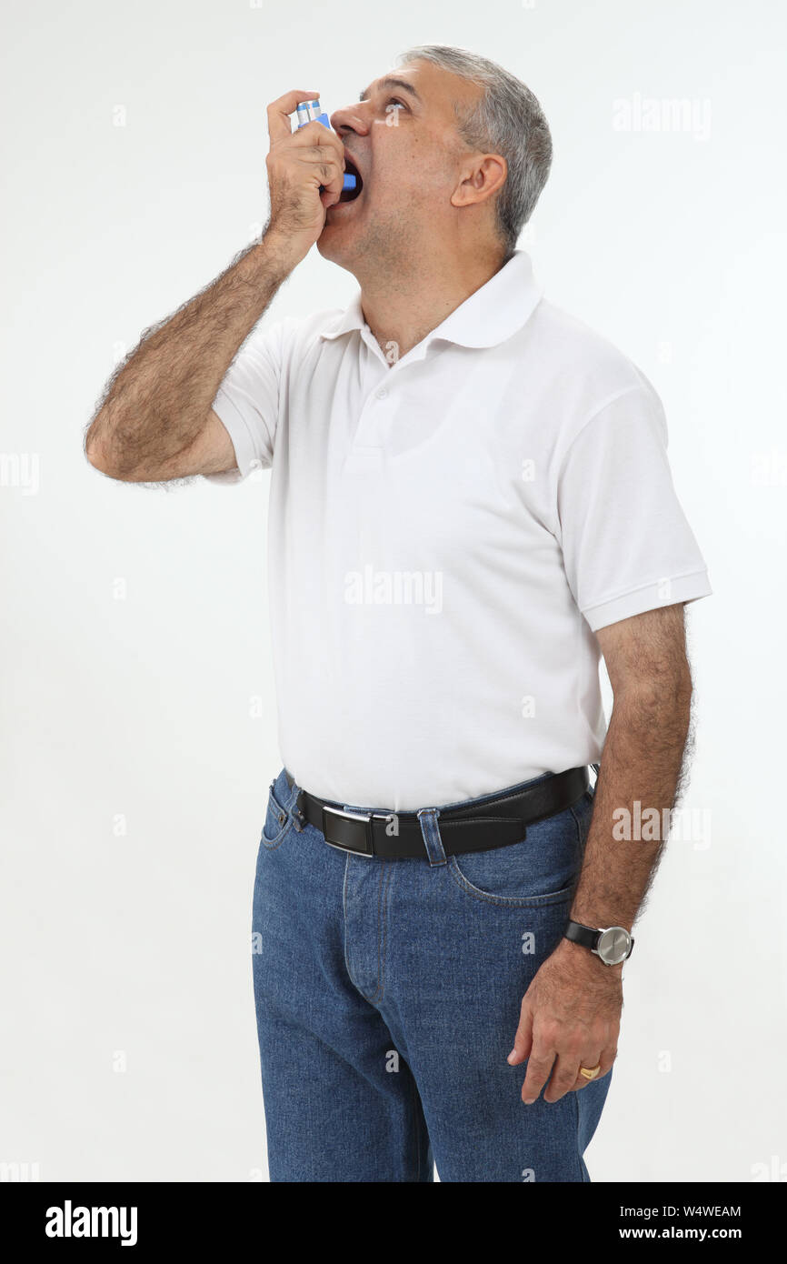 Old man using asthma inhaler Stock Photo - Alamy