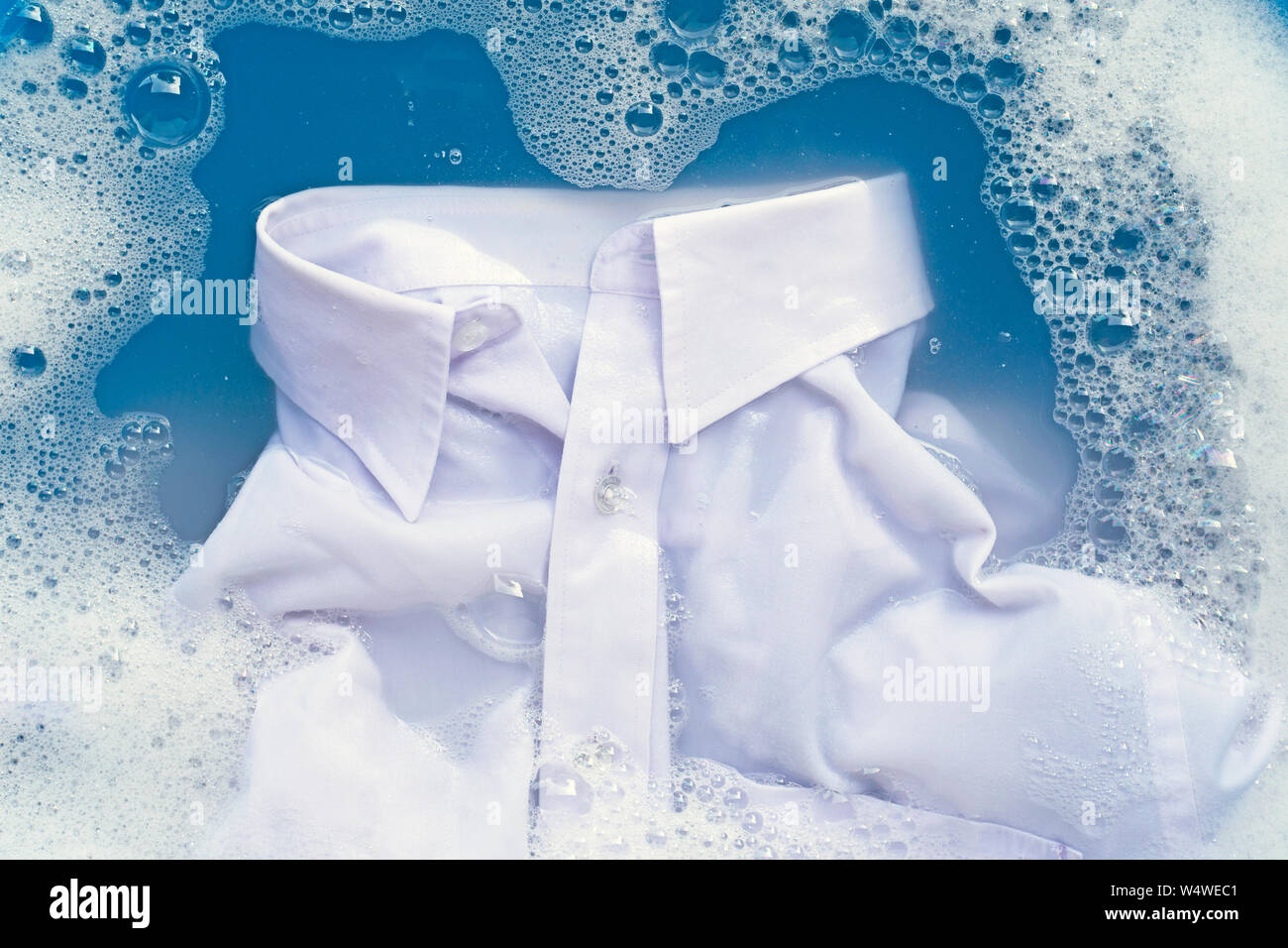 White shirt soak in powder detergent water dissolution, washing cloth ...