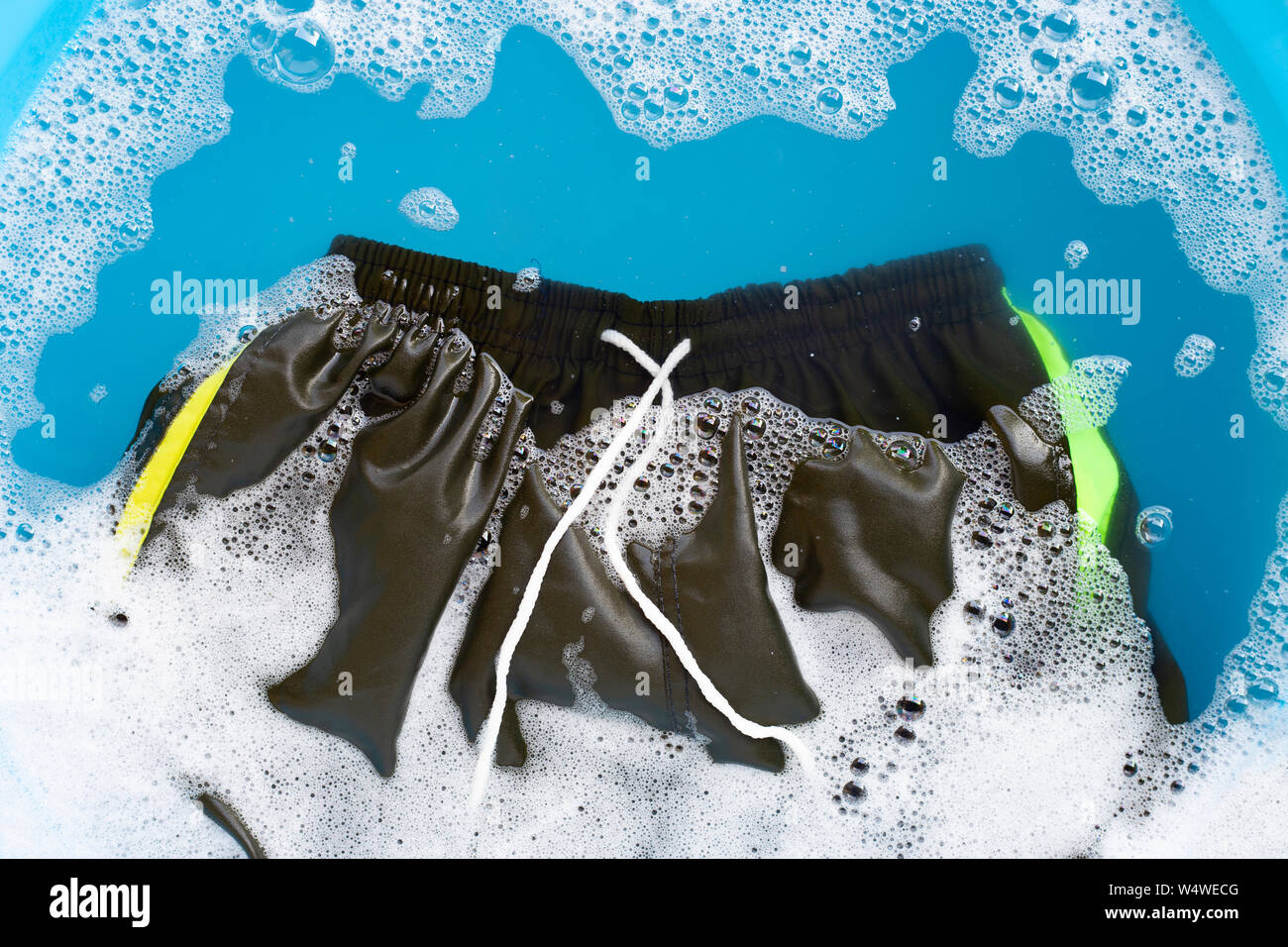 Male shorts soak in powder detergent water dissolution, washing cloth ...