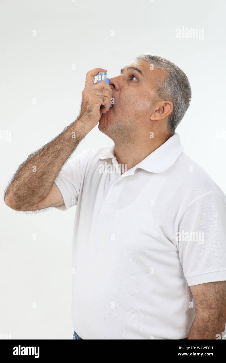 Old man using asthma inhaler Stock Photo - Alamy