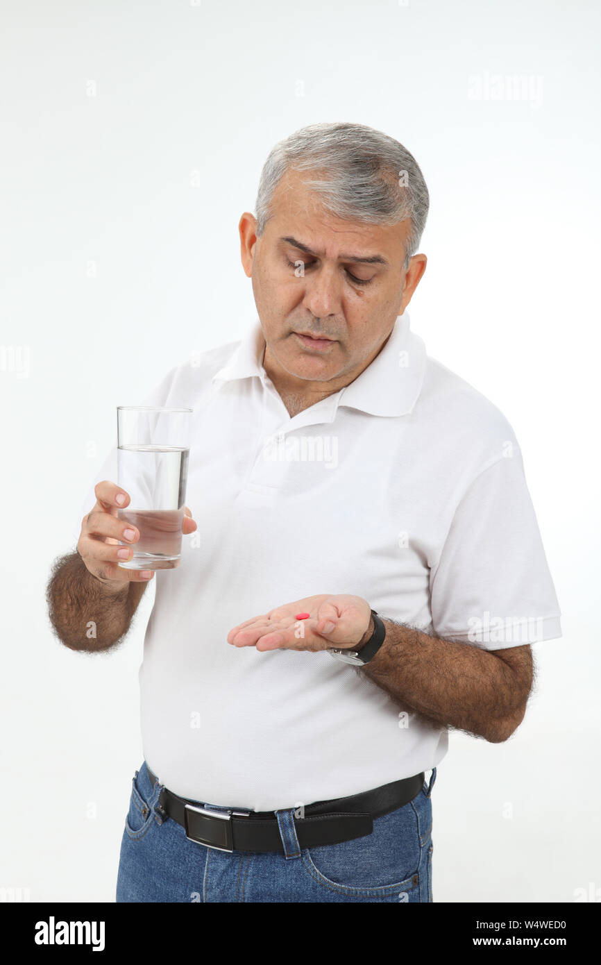 Old man taking medicine Stock Photo - Alamy