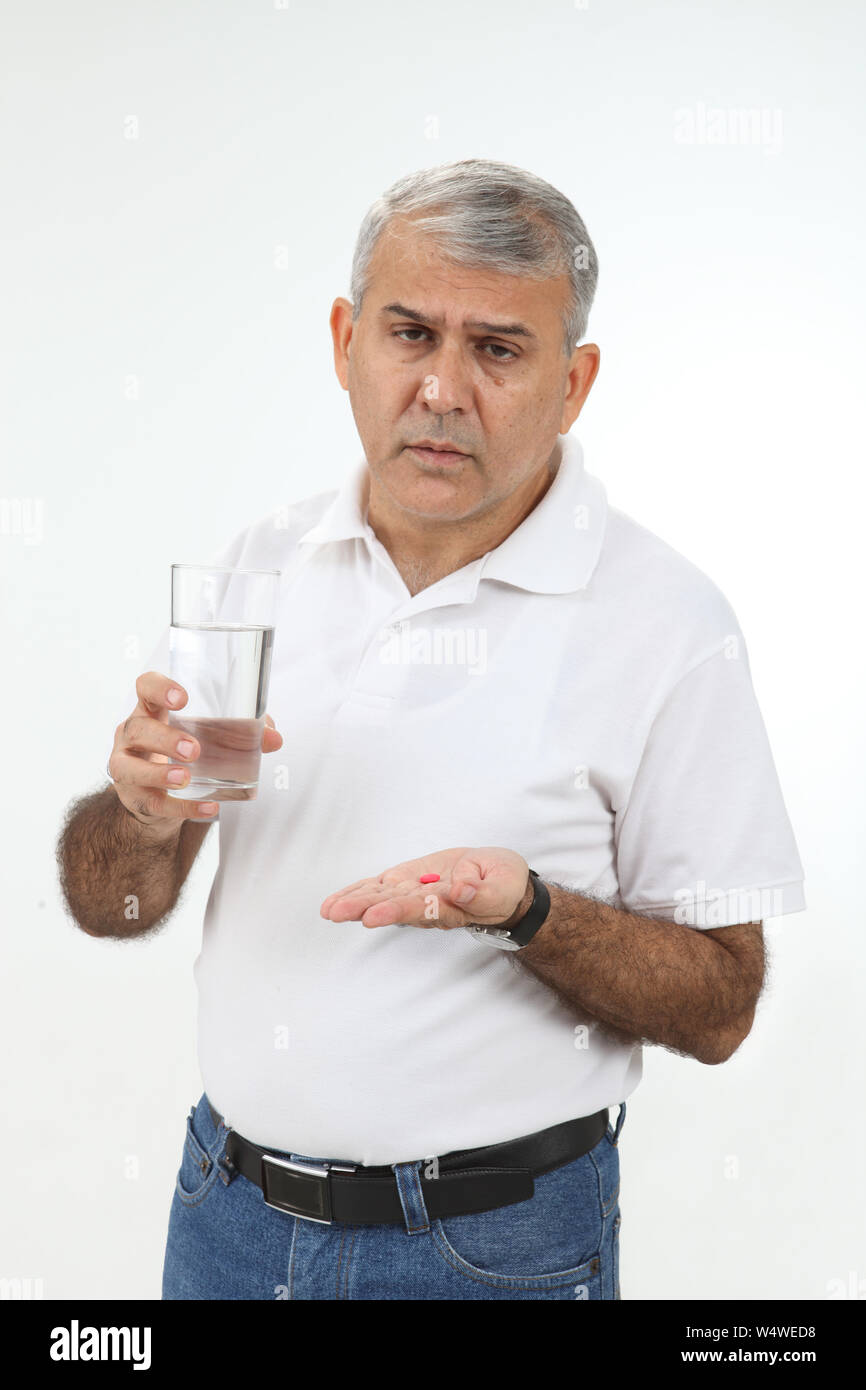 Indian old man taking medicine hi-res stock photography and images - Alamy