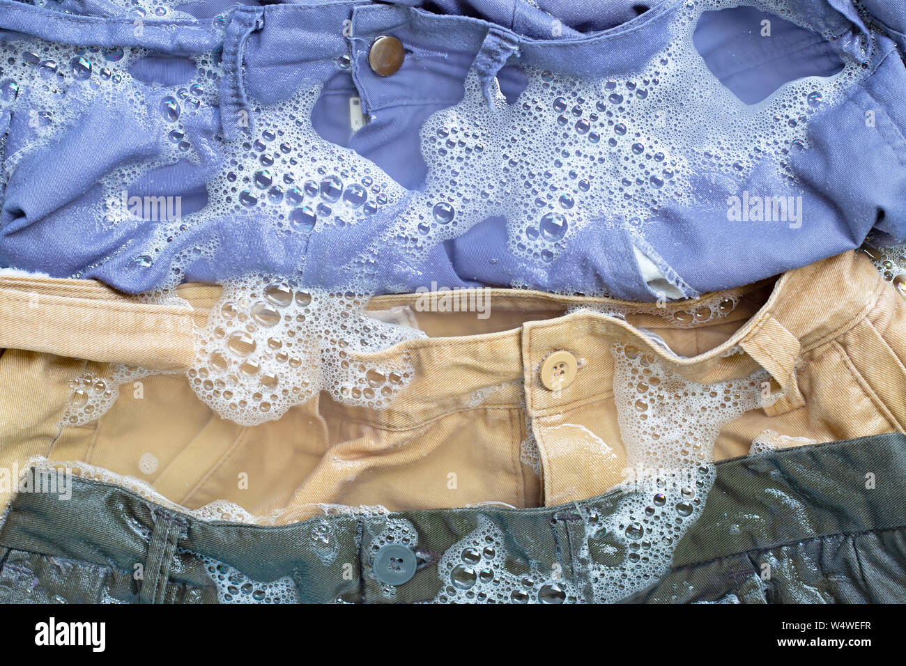 Trousers soak in powder detergent water dissolution, washing cloth ...