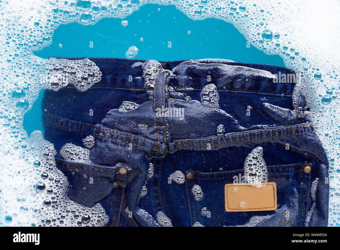 Jeans soak in powder detergent water dissolution, washing cloth ...