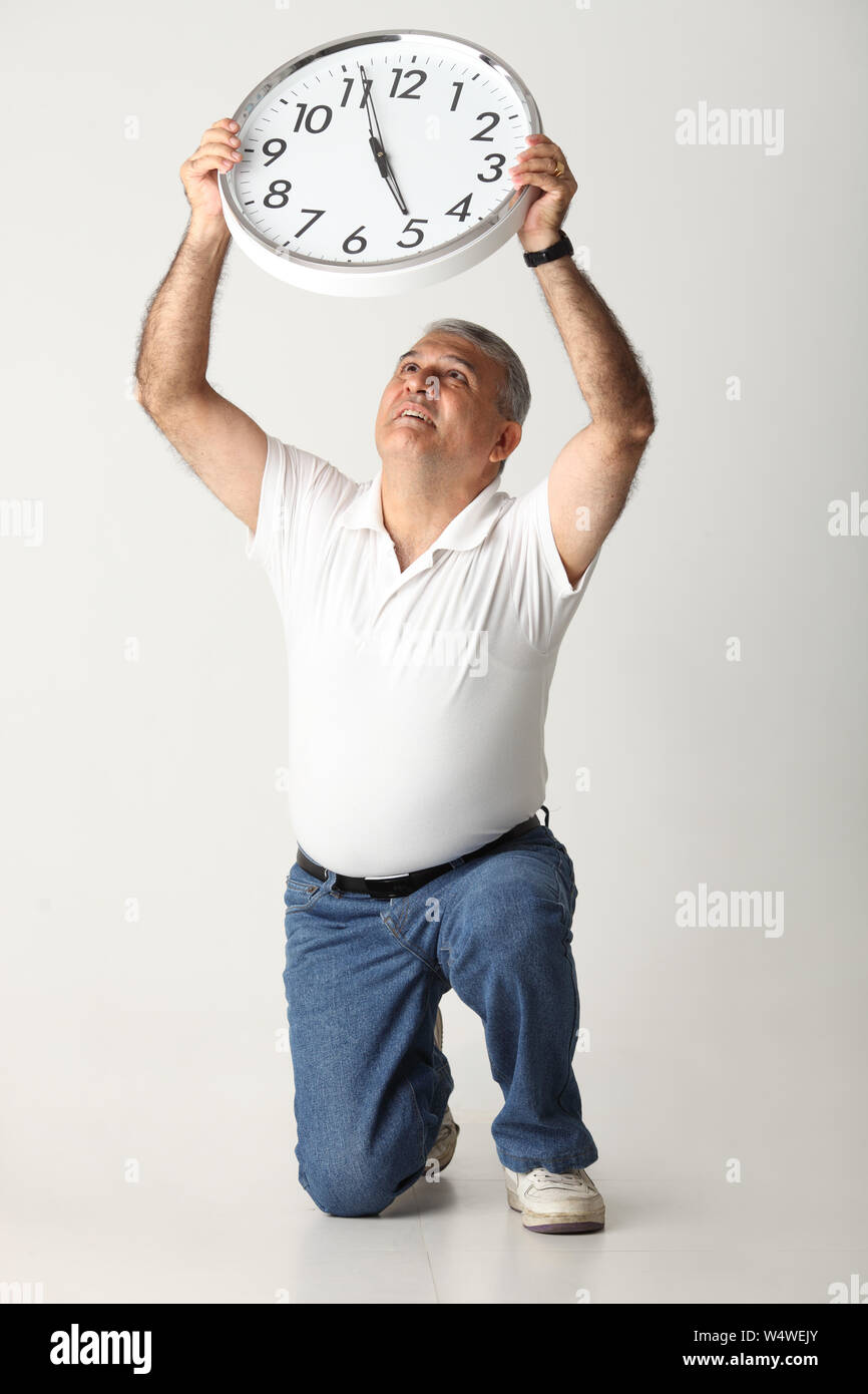 Old man carrying a clock Stock Photo - Alamy