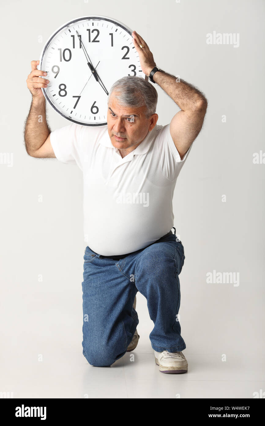 Man carrying a clock on his shoulder Stock Photo - Alamy