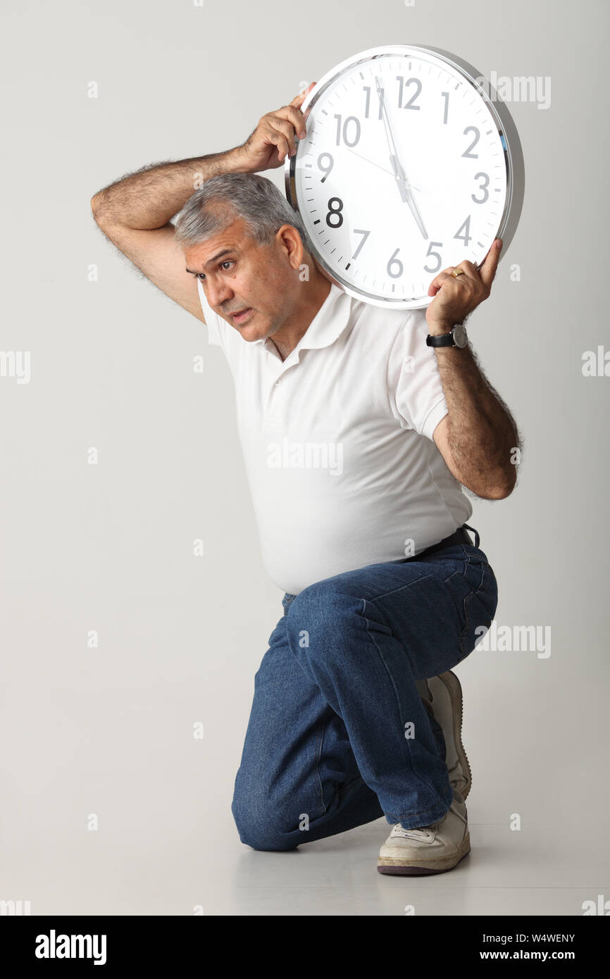 Man carrying a clock on his shoulder Stock Photo - Alamy