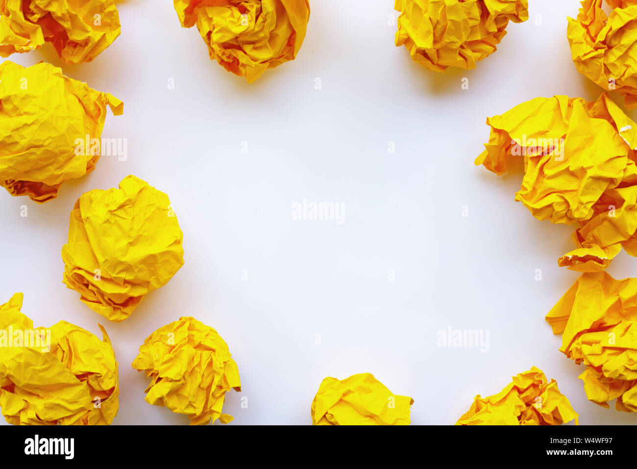 Yellow crumpled paper ball isolated on white background. Copy space ...