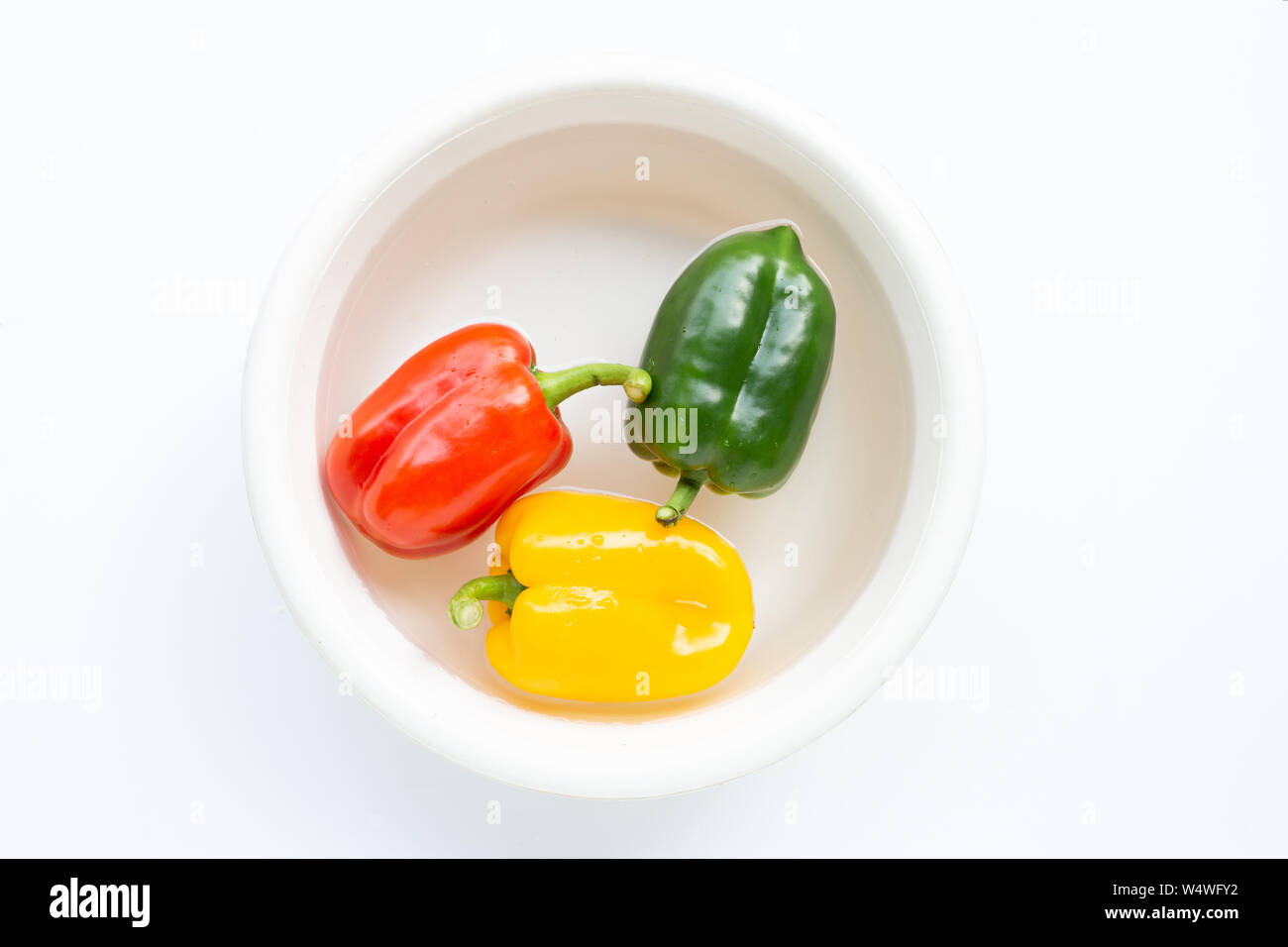 Bell pepper soaked in water. Washing fresh vegetables on white ...