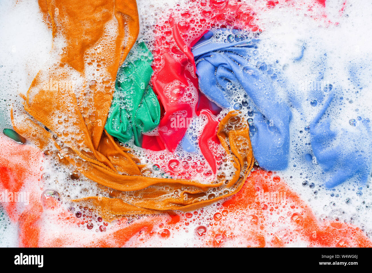 Color clothes soak before washing. Top view Stock Photo - Alamy