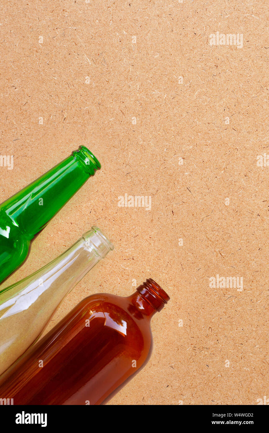 Glass bottles on plywood background. Copy space Stock Photo - Alamy