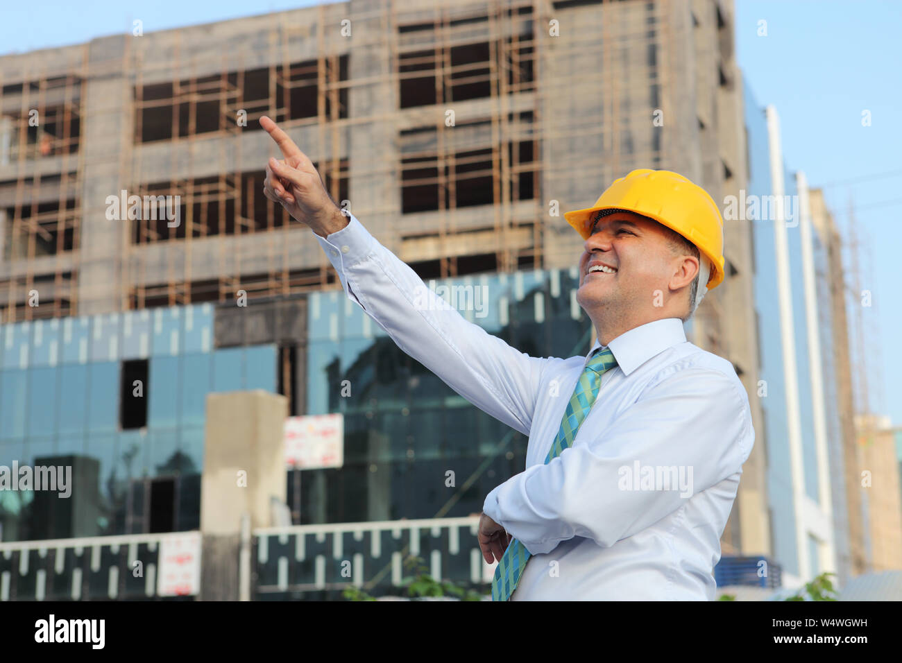 Architect pointing at construction site Stock Photo - Alamy