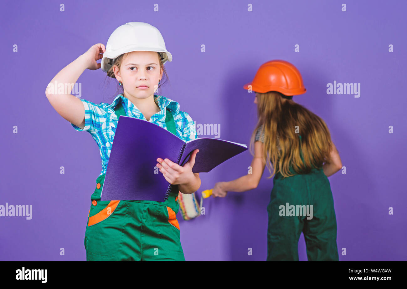 small girls repairing together in workshop. Labor day. 1 may ...