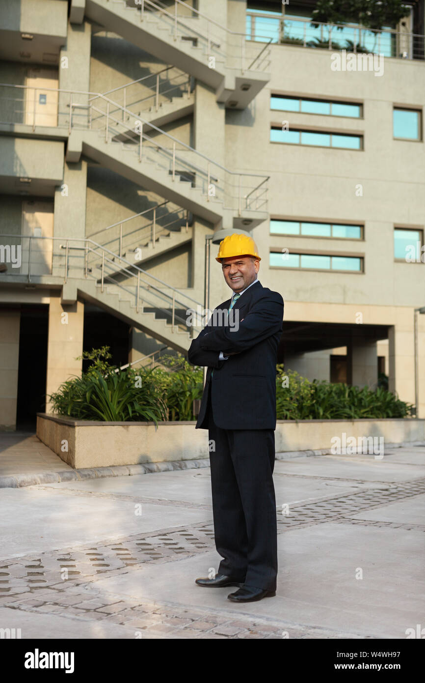Architect standing with his arms crossed Stock Photo - Alamy