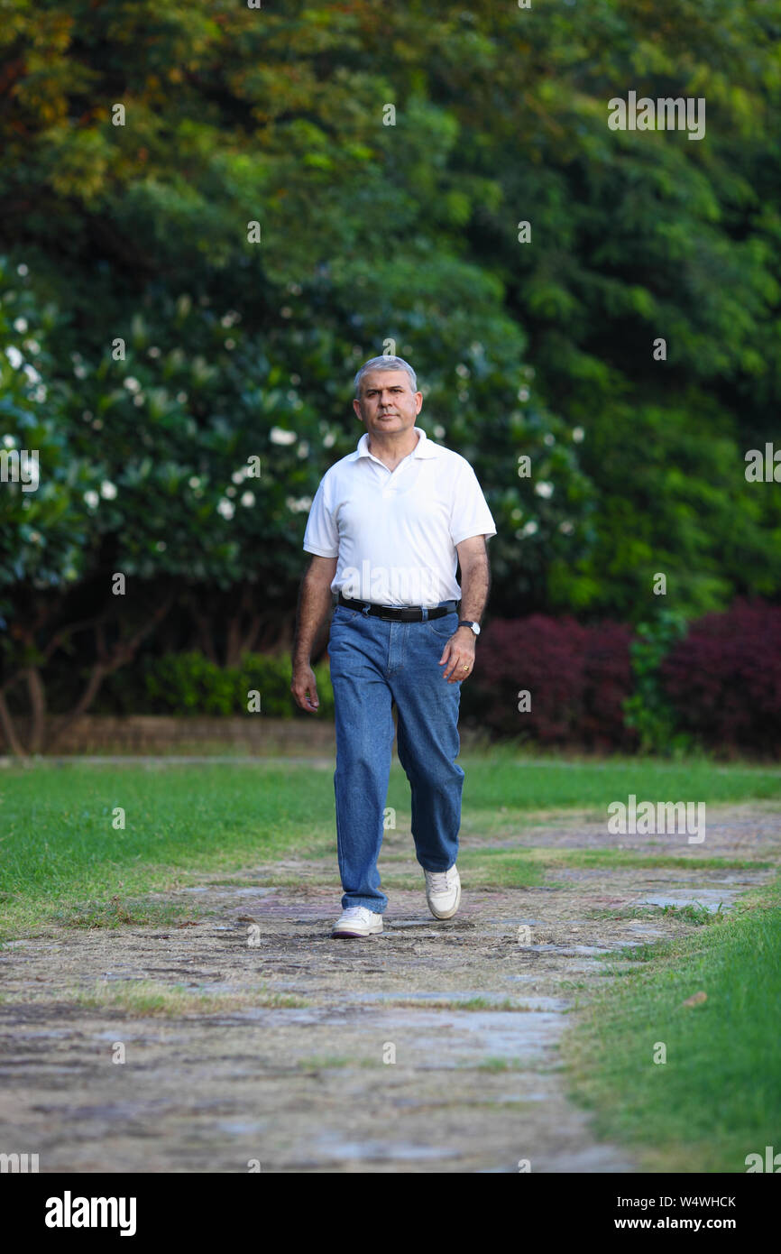 Man walking in a park Stock Photo - Alamy