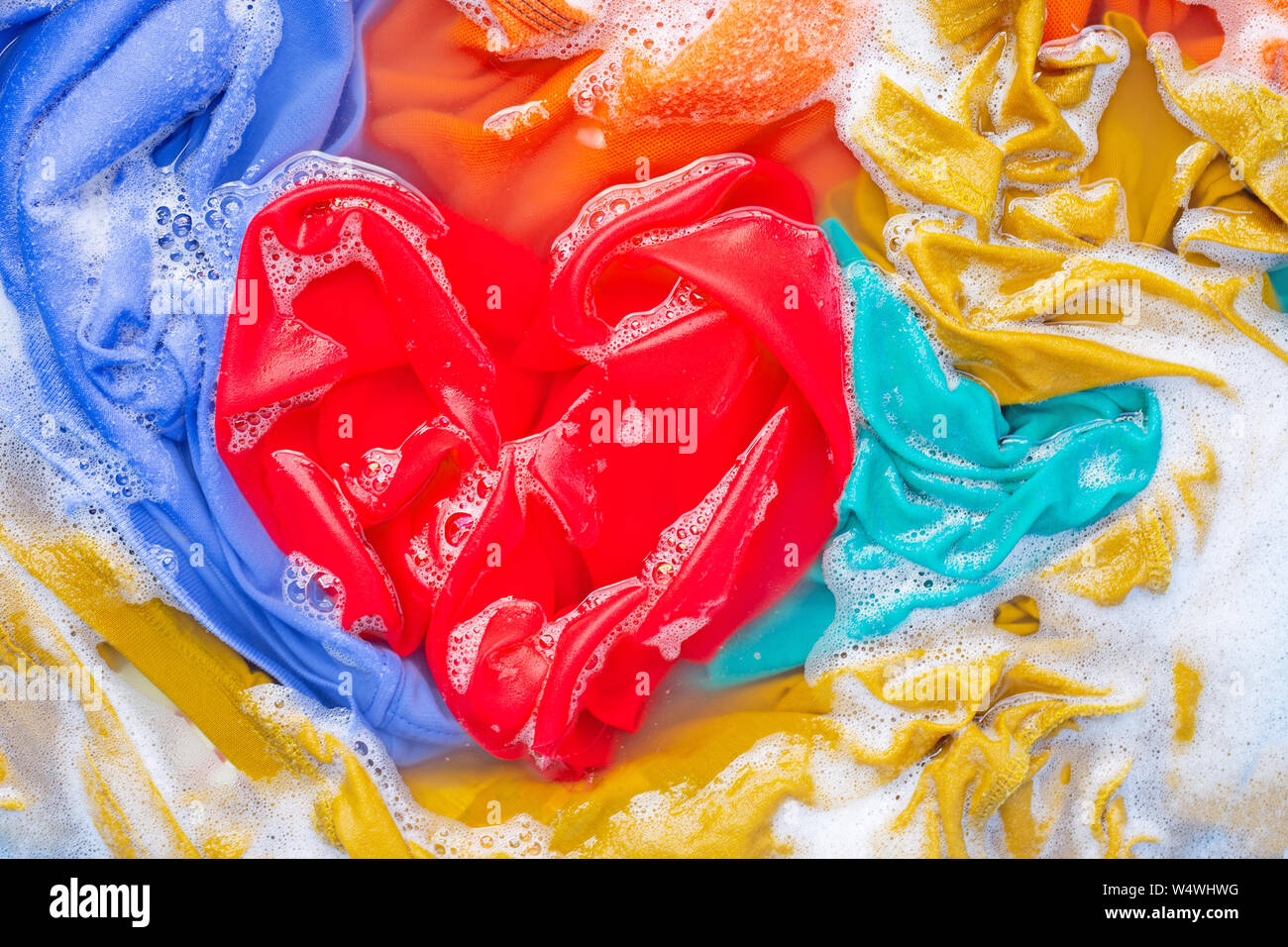 Color clothes soak before washing. Top view Stock Photo - Alamy