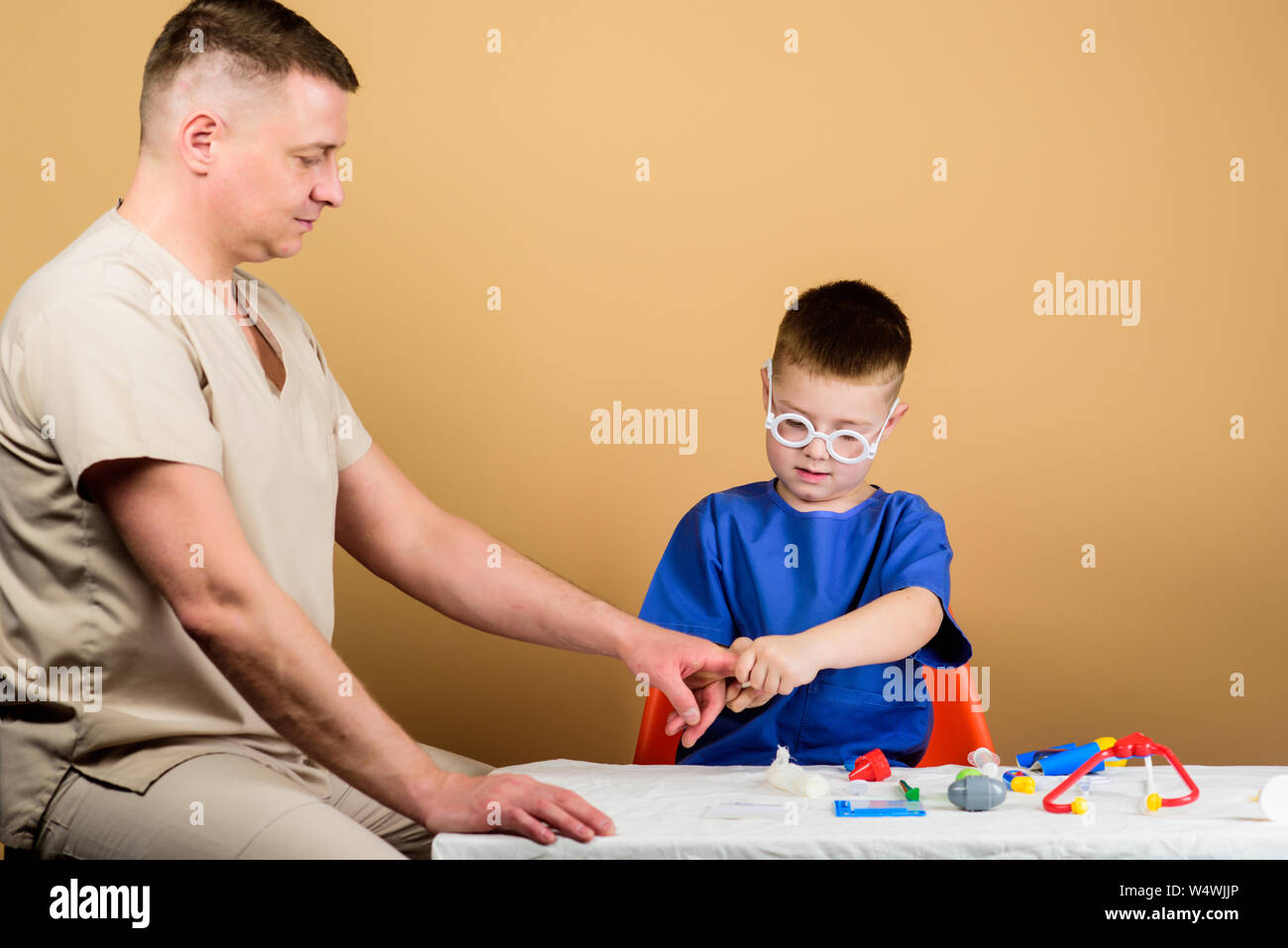 Trauma and injurie. Medicine concept. Kid little doctor sit table ...