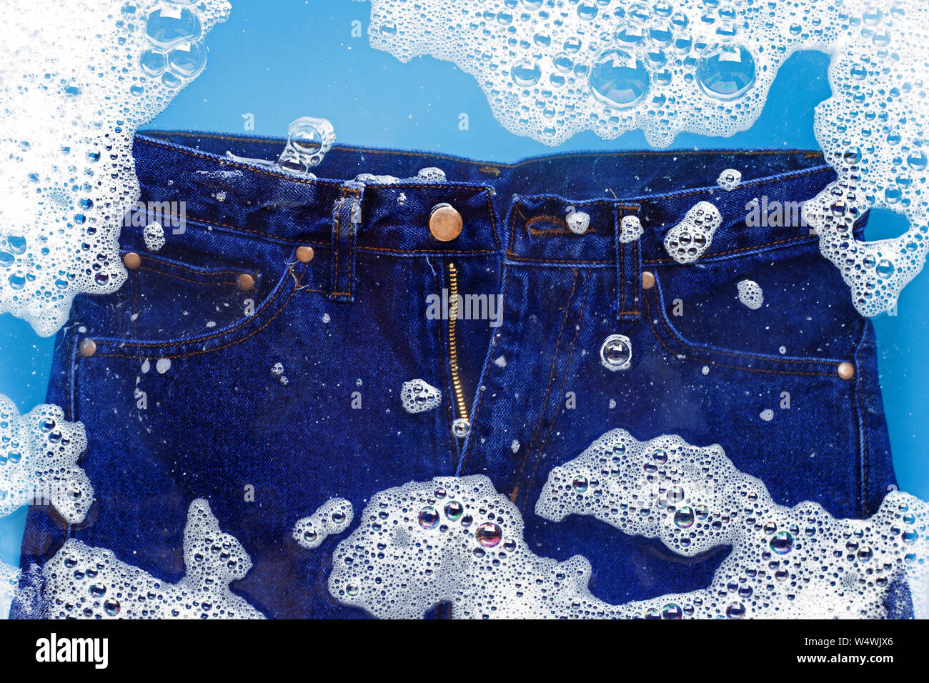 Jeans soak in powder detergent water dissolution, washing cloth ...
