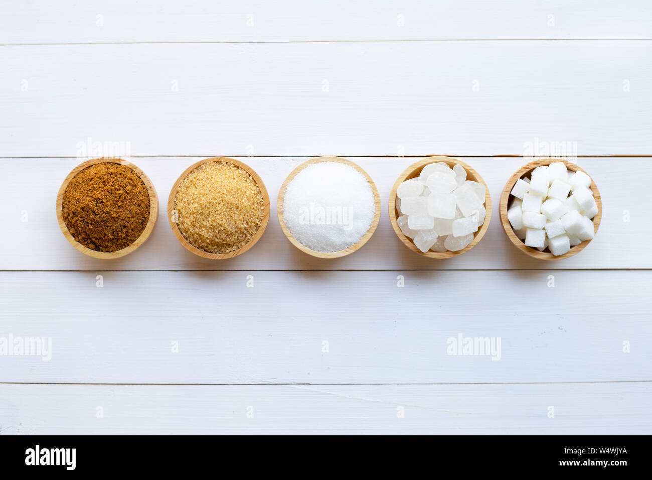 Various types of sugar on white wooden background Stock Photo - Alamy