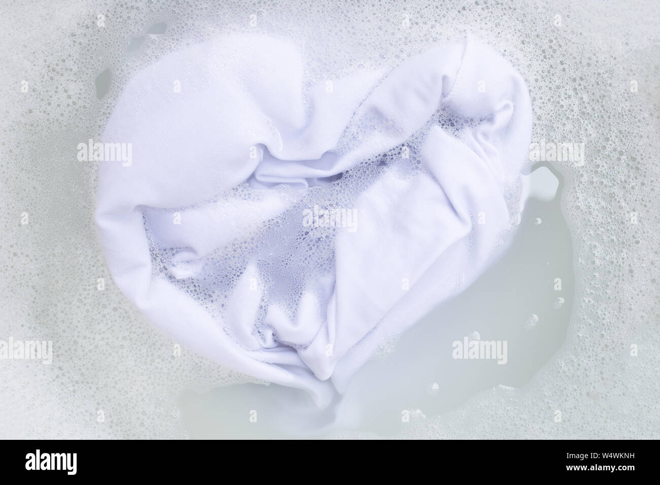 Soak a cloth before washing, white cloth. Top view Stock Photo - Alamy