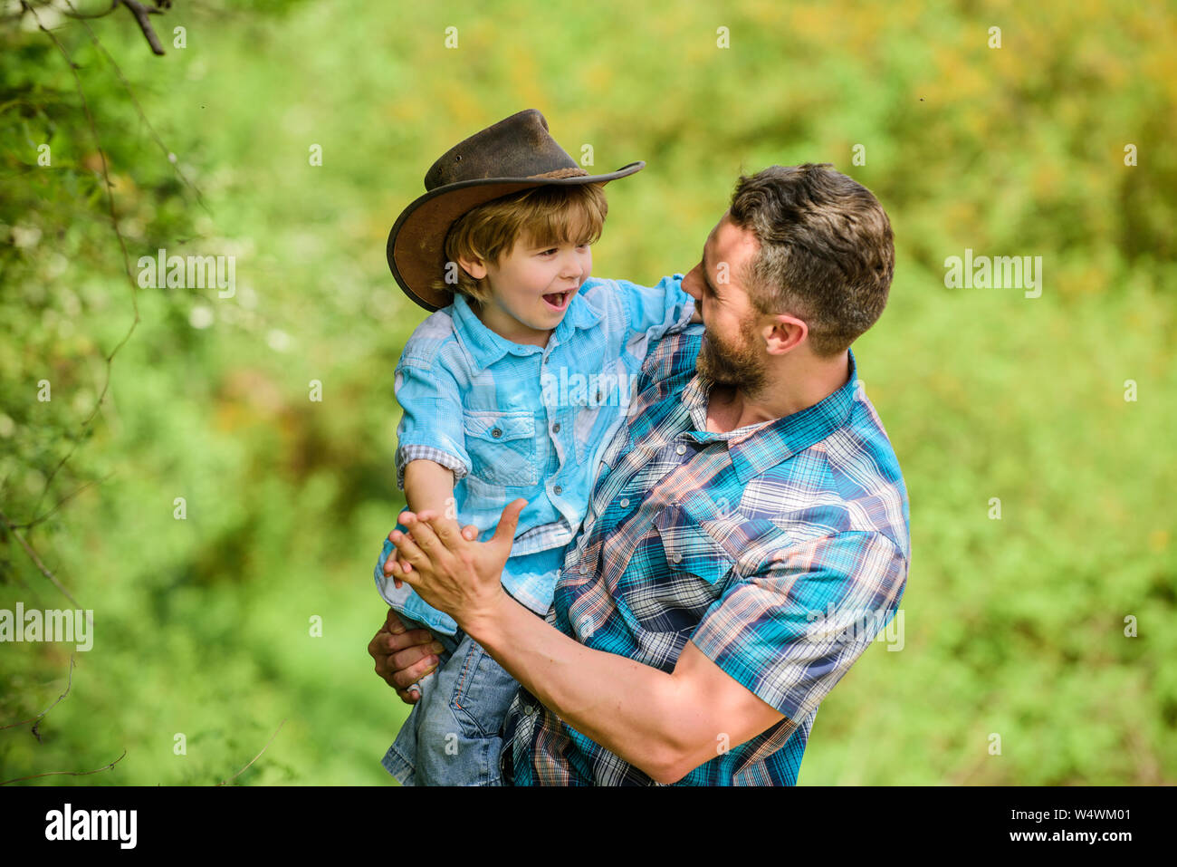 Rustic family. Growing cute cowboy. Small helper in garden. Little boy ...